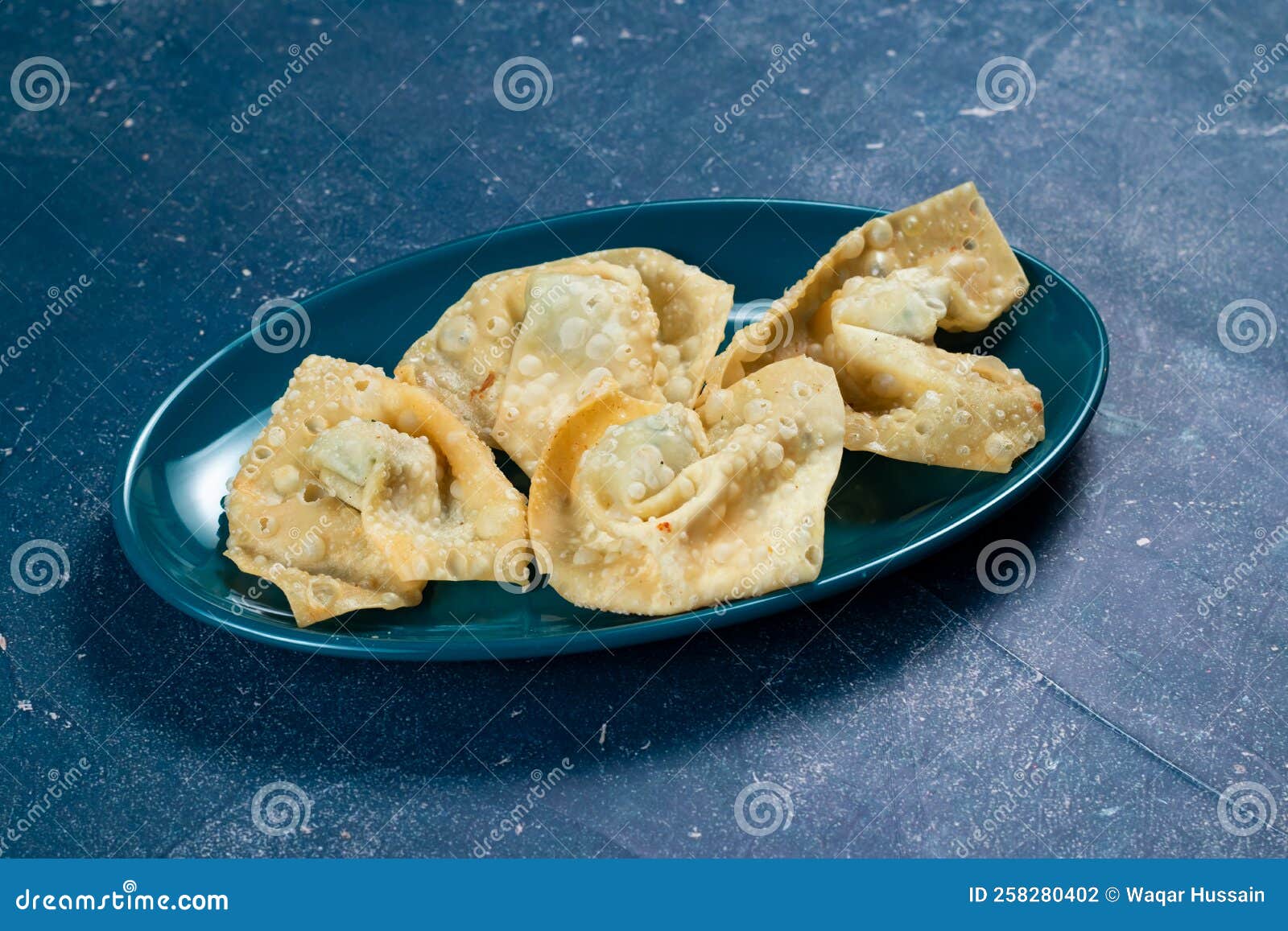 Crispy Fried Wonthon Dim Sum Wraps with Tomato Sauce Served in a Dish ...
