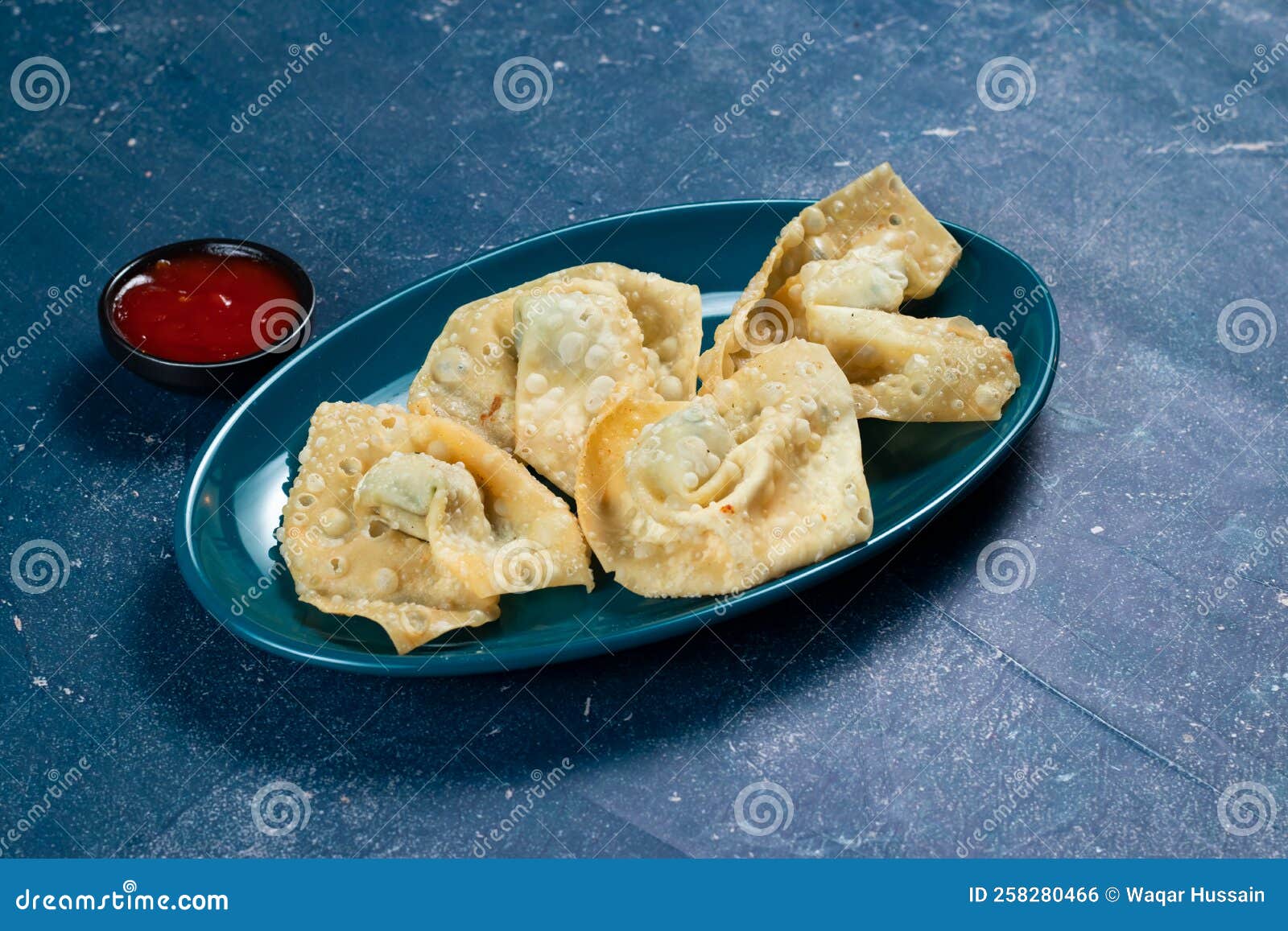 Crispy Fried Wonthon Dim Sum Wraps with Tomato Sauce Served in a Dish ...