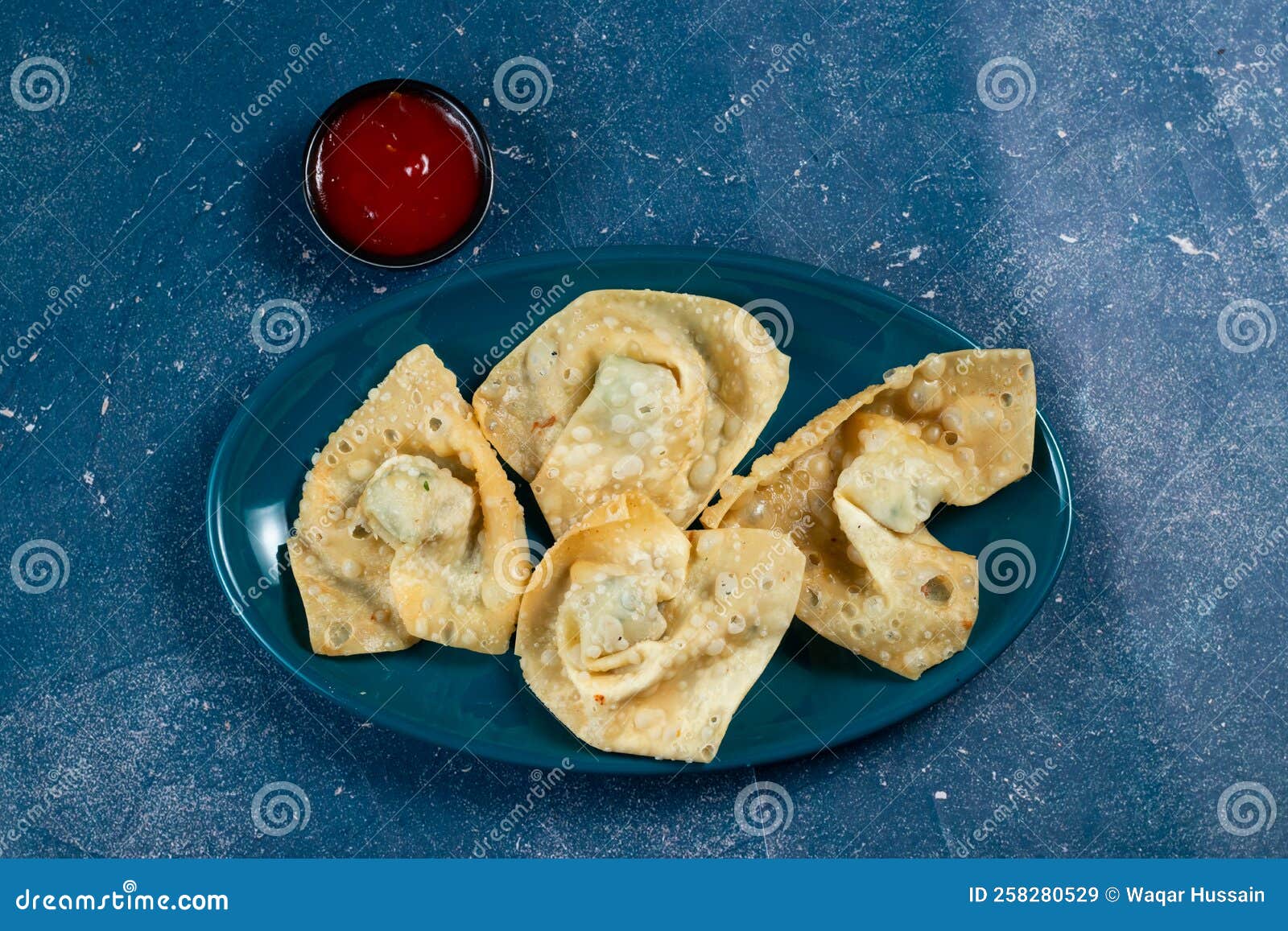 Crispy Fried Wonthon Dim Sum Wraps with Tomato Sauce Served in a Dish ...