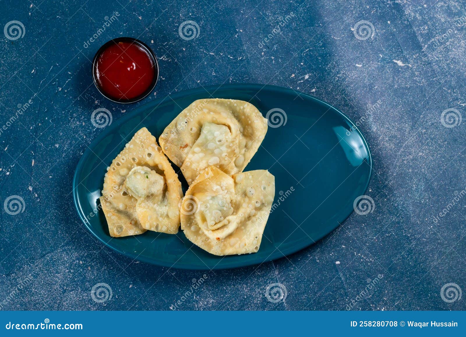 Crispy Fried Wonthon Dim Sum Wraps with Tomato Sauce Served in a Dish ...