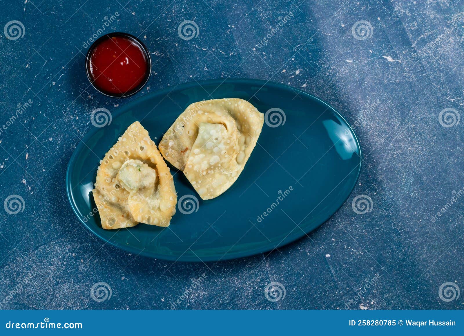 Crispy Fried Wonthon Dim Sum Wraps with Tomato Sauce Served in a Dish ...