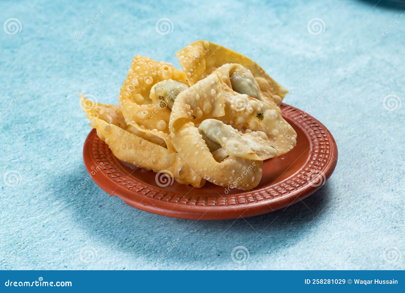 Crispy Fried Wonthon Dim Sum Wraps with Tomato Sauce Served in a Dish ...