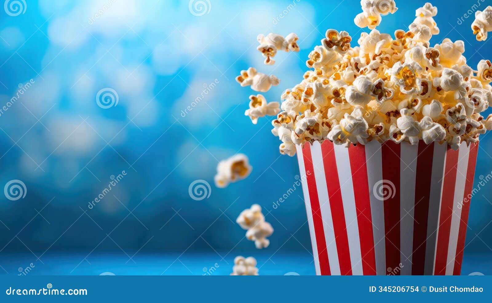 Crispy Popcorn Spilling from Red and White Striped Bucket, Creating Fun ...