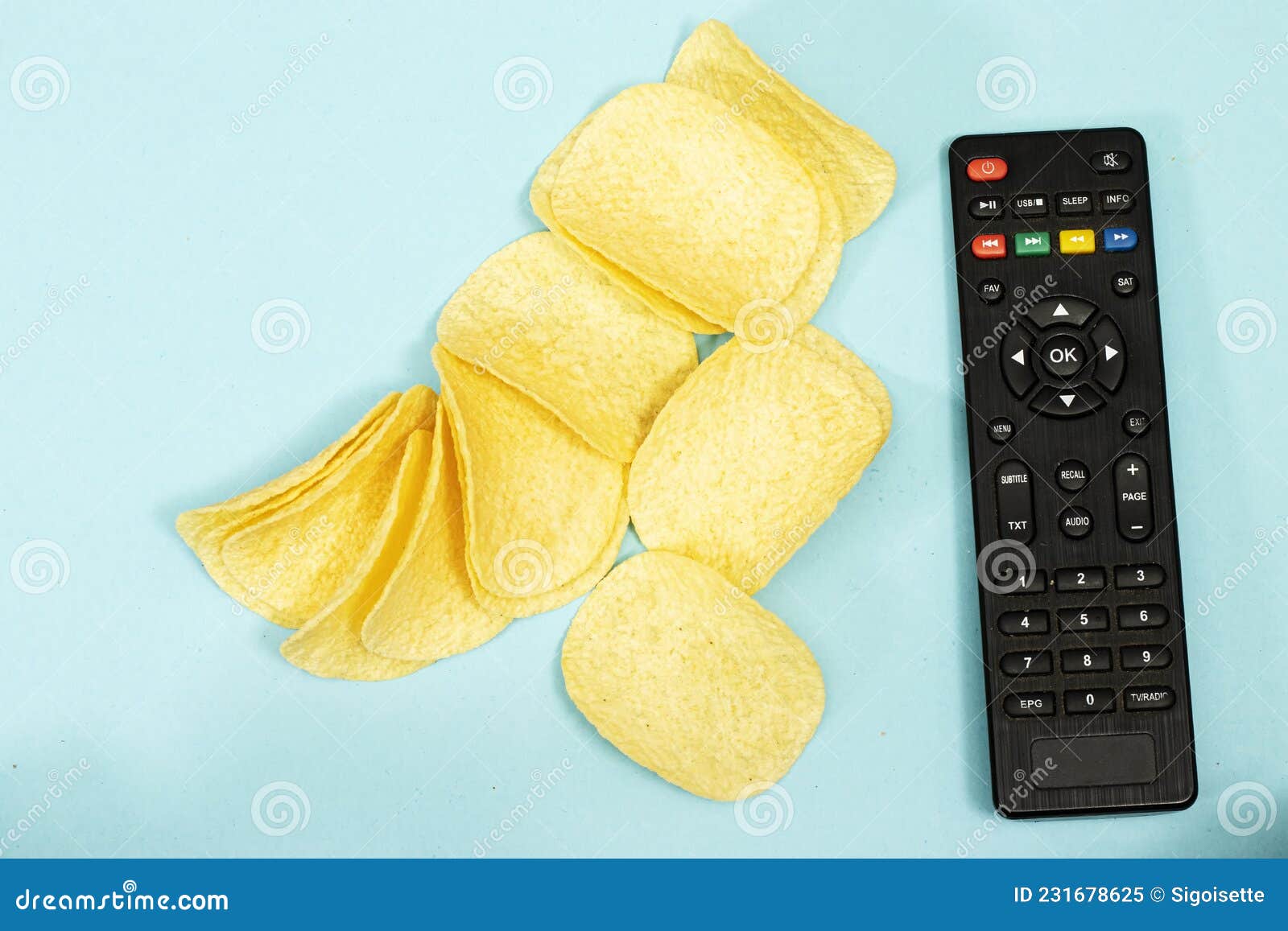 Crispy Potato Chips and Remote Control on Blue Background Stock Image ...