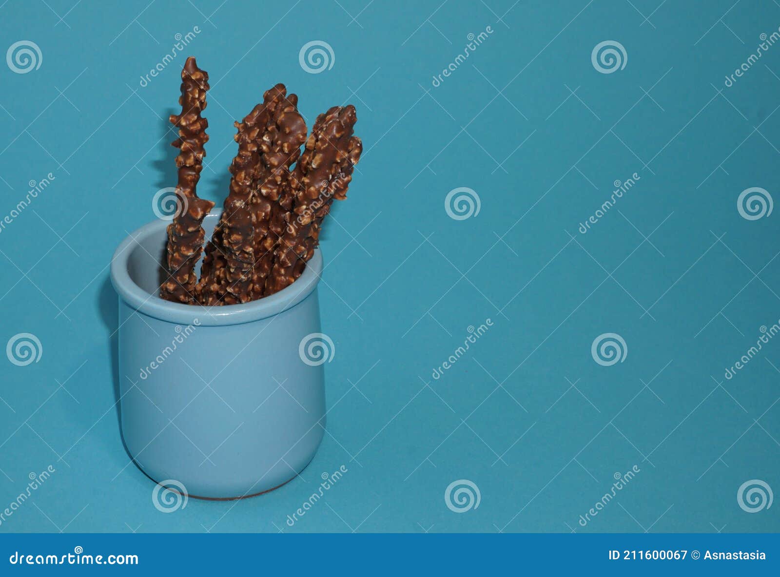 Crispy Sticks with Hazelnut Sprinkles in Chocolate on a Blue Background ...