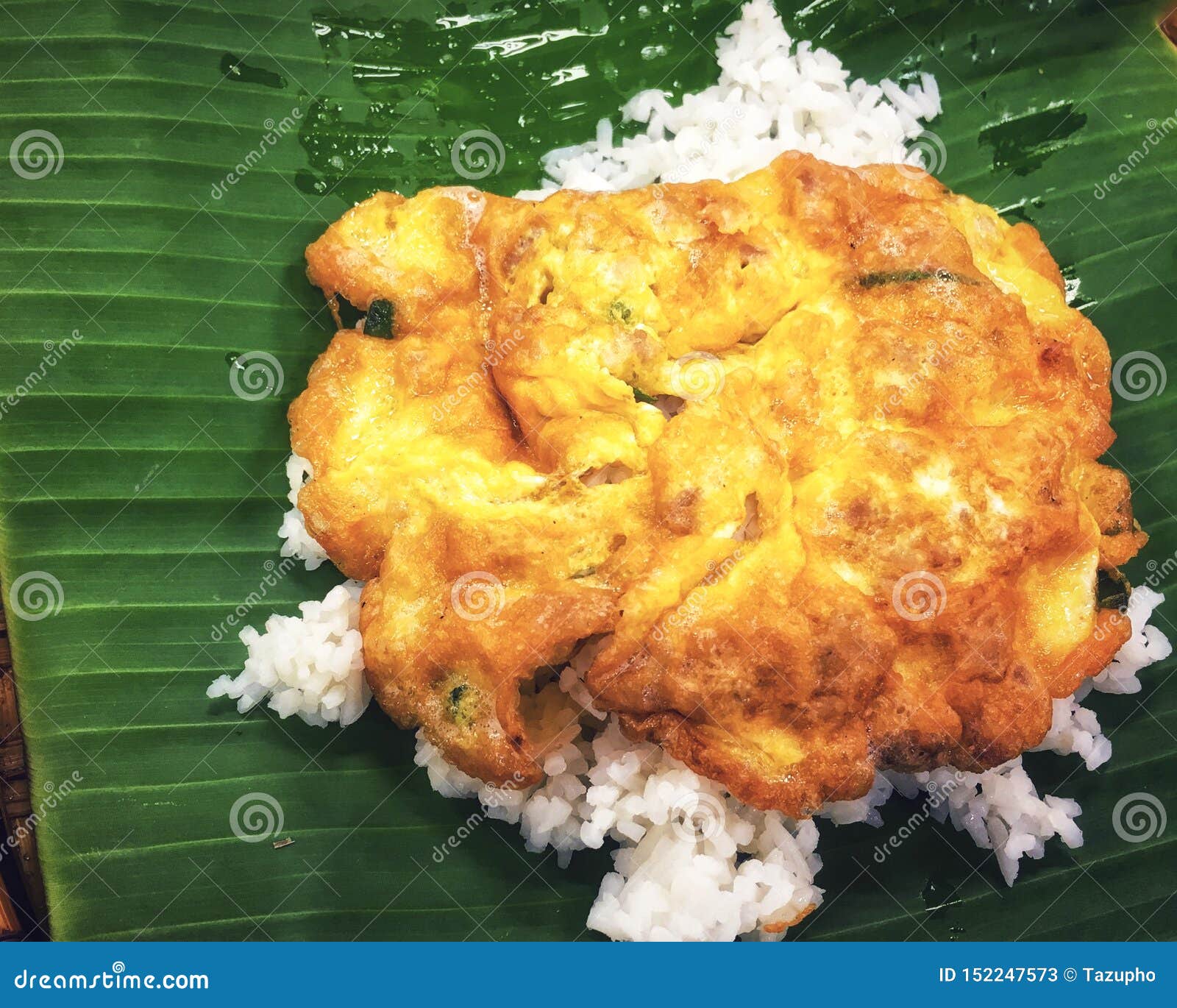 Crispy Thai Omelet Over Rice Served in the Banana Leaf Stock Image ...