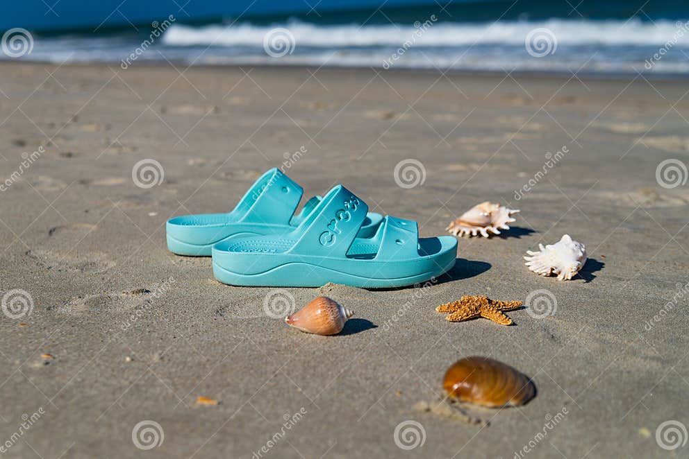 Crocs Shoes on the Sand by the Ocean with Shells and Starfish Editorial ...