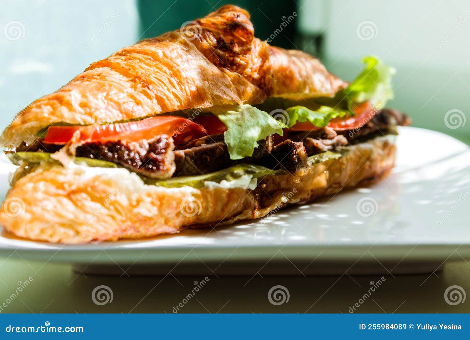 Croissant with Beef and Fresh Vegetables Illuminated by Sunlight. Stock ...
