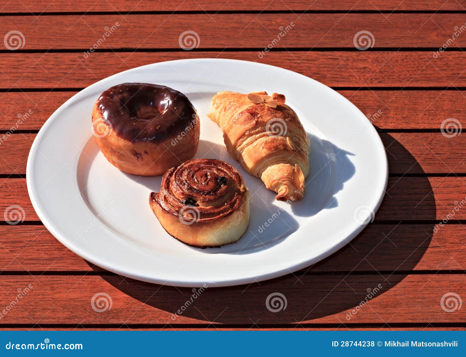Croissant, Donut in Chocolate and Roll with Raisin Stock Photo - Image ...