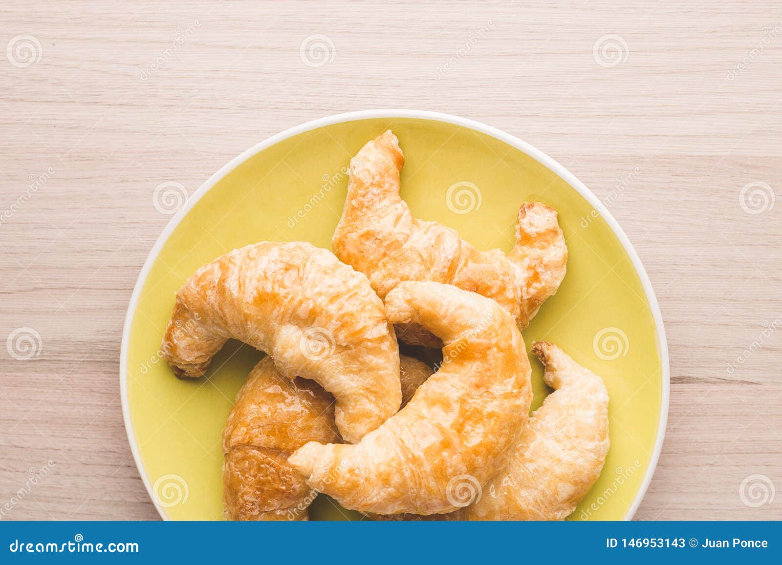 Croissant on a green dish stock image. Image of kitchen - 146953143