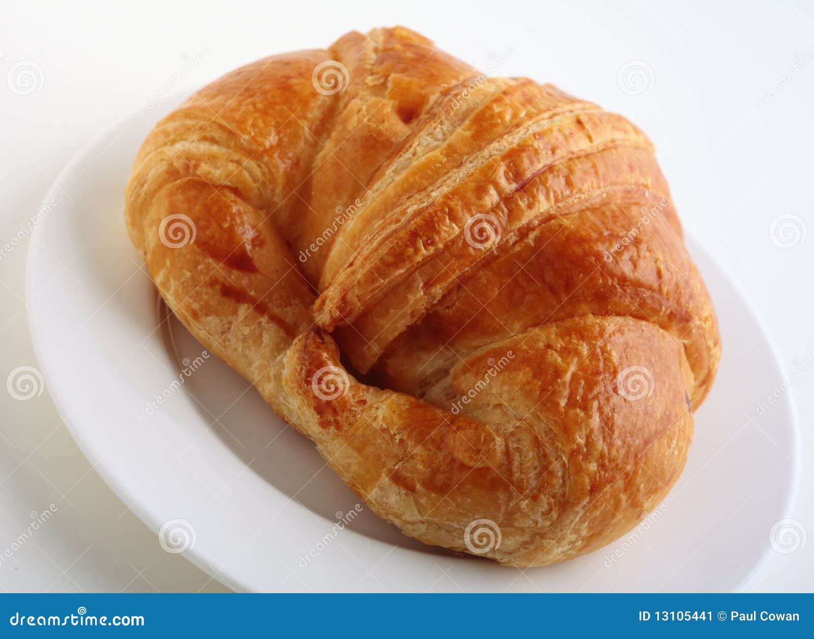 Croissant on white plate stock image. Image of bread - 13105441