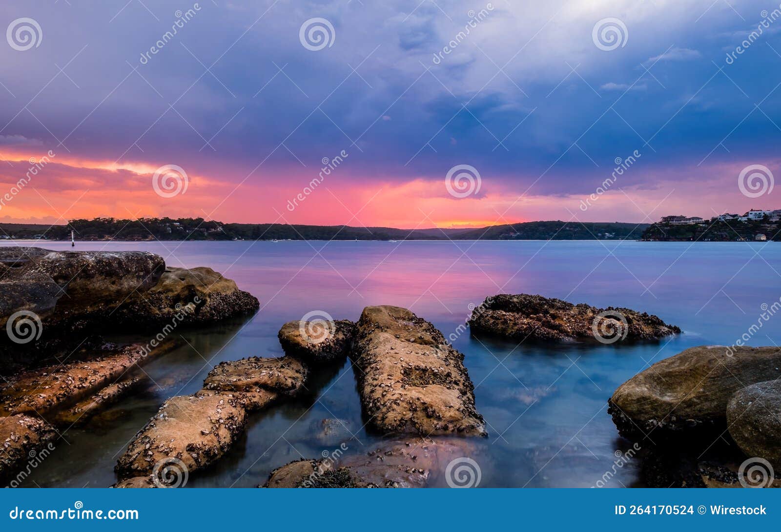 Cronulla Beach View at Sunset with Sunlit Rocky Cliffs and Water with ...