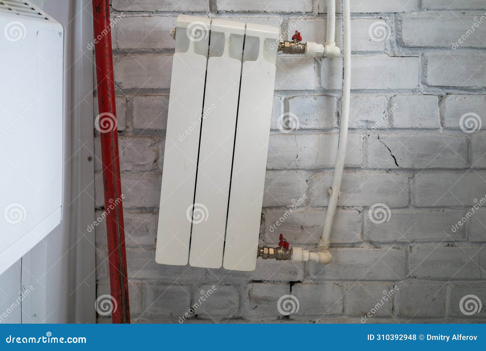 A Crookedly Installed White Heating Radiator of Three Sections on a ...