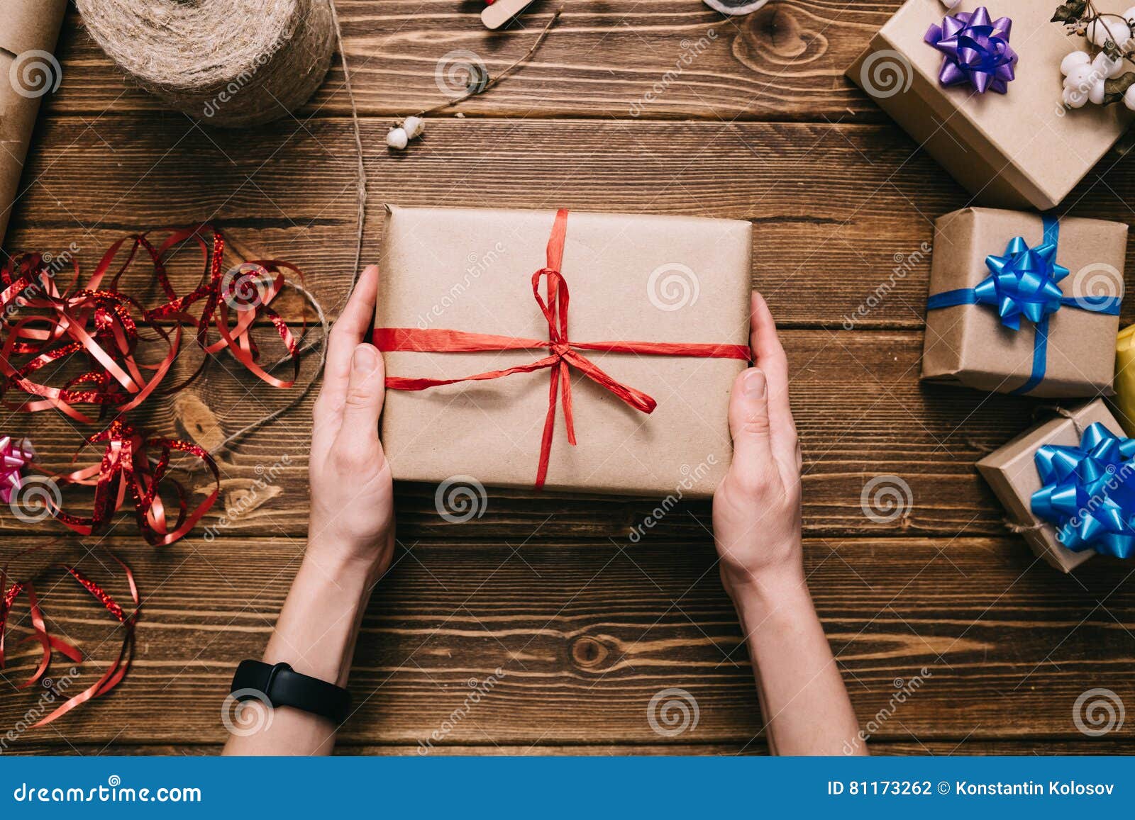 Crop Hands Holding Wrapped Present on Table Stock Photo - Image of ...