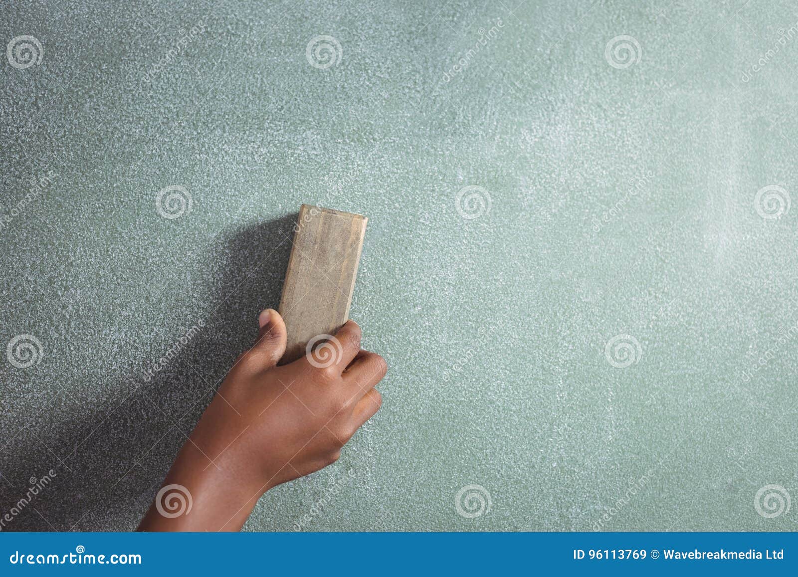 Cropped Hand of Student Holding Duster on Blackboard Stock Image ...