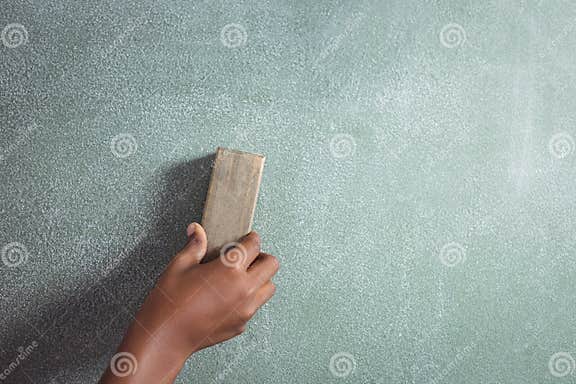 Cropped Hand of Student Holding Duster on Blackboard Stock Image ...