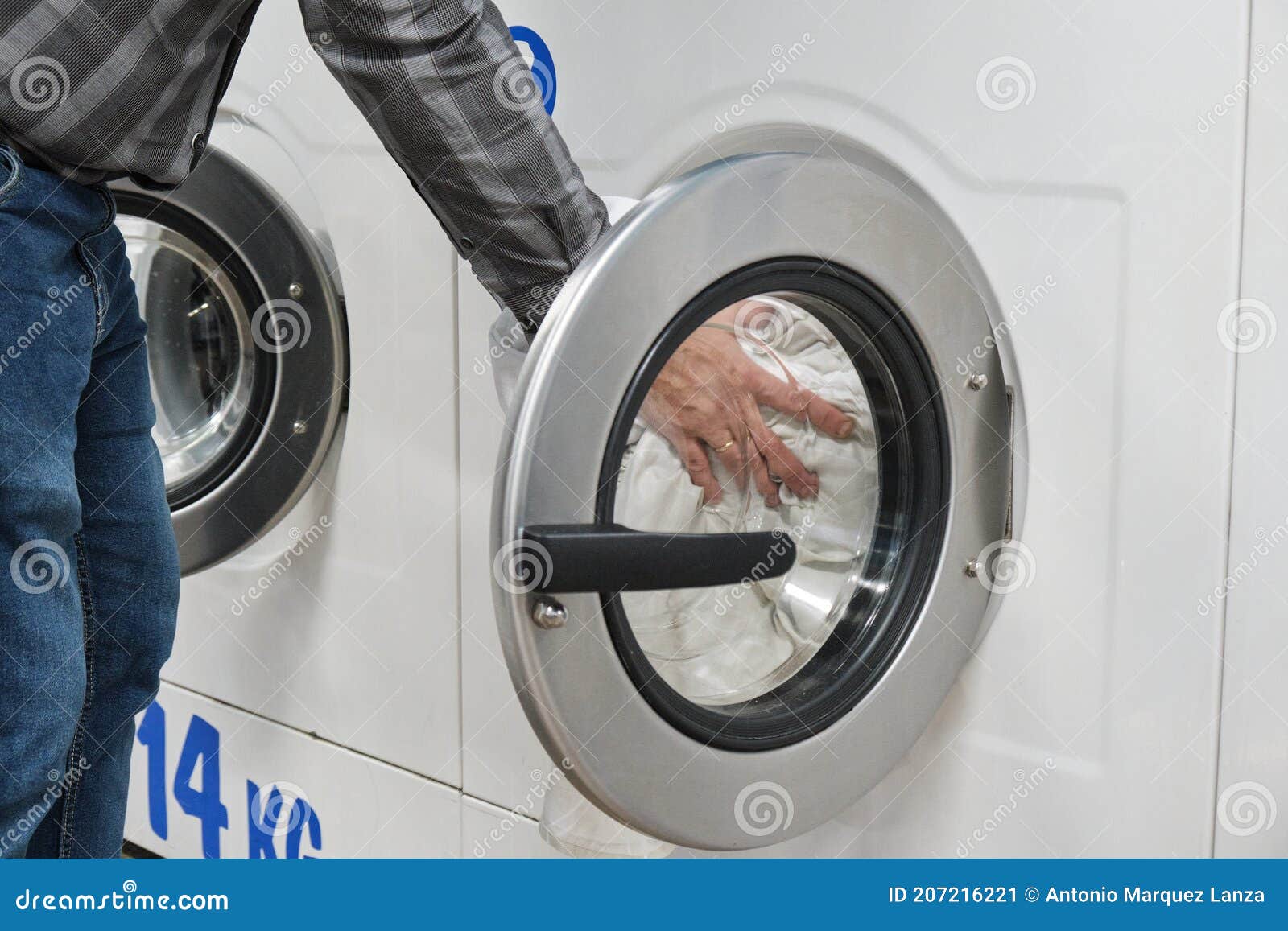 Cropped Hands of Man Putting Clothes in Washing Machine at Laundry ...