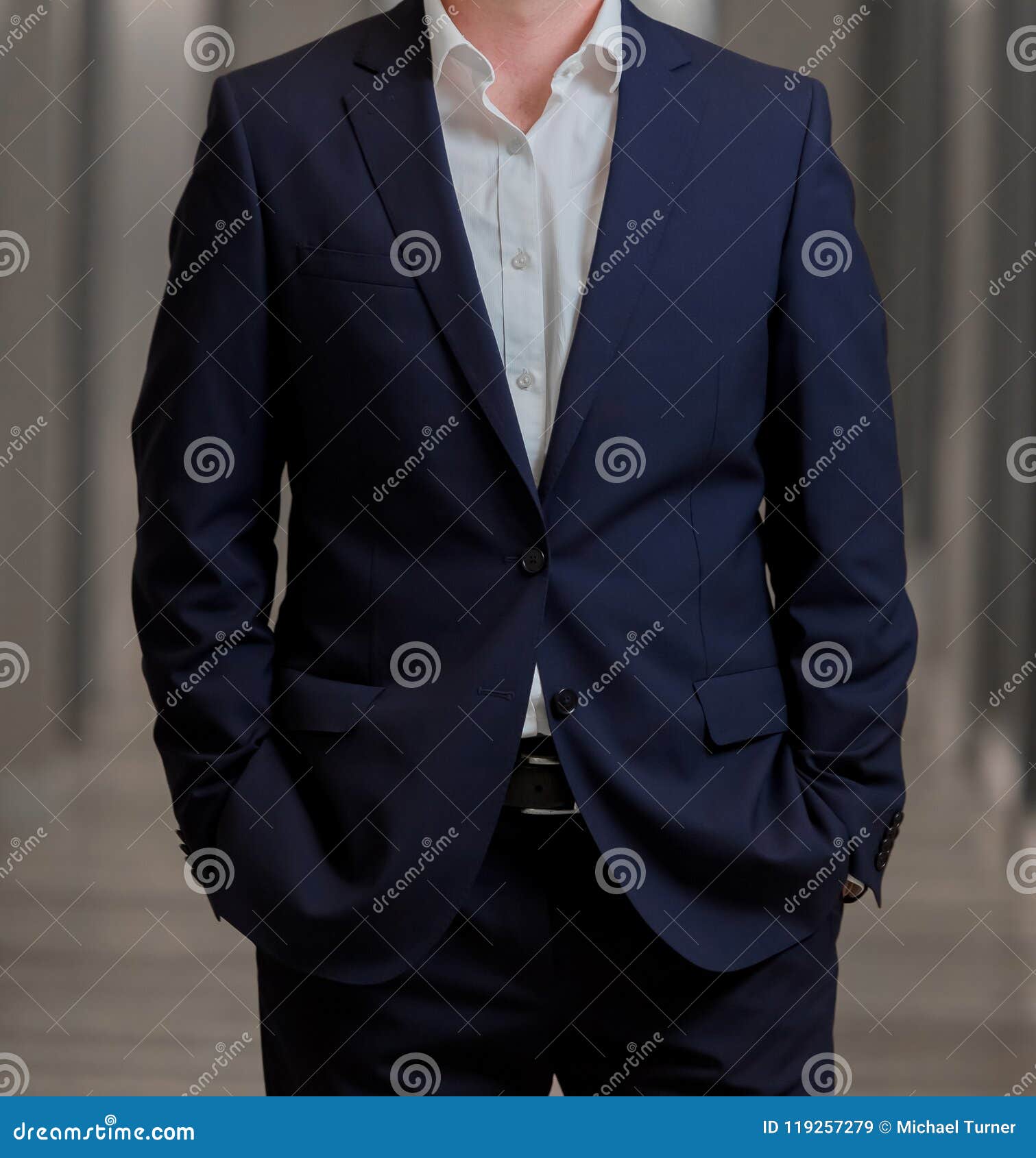 Cropped Head Man Standing in a Smart Suit with Hands in Pockets ... Cropped Head Man Standing in a Smart Suit with Hands in Pockets ...