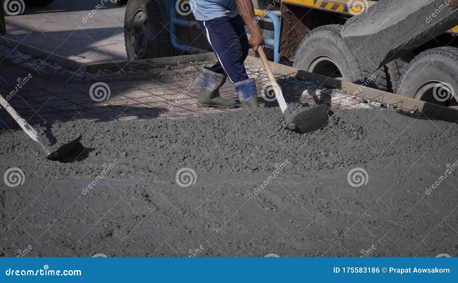 Construction Worker Using Hoe To Spread Concrete on the Floor in ...