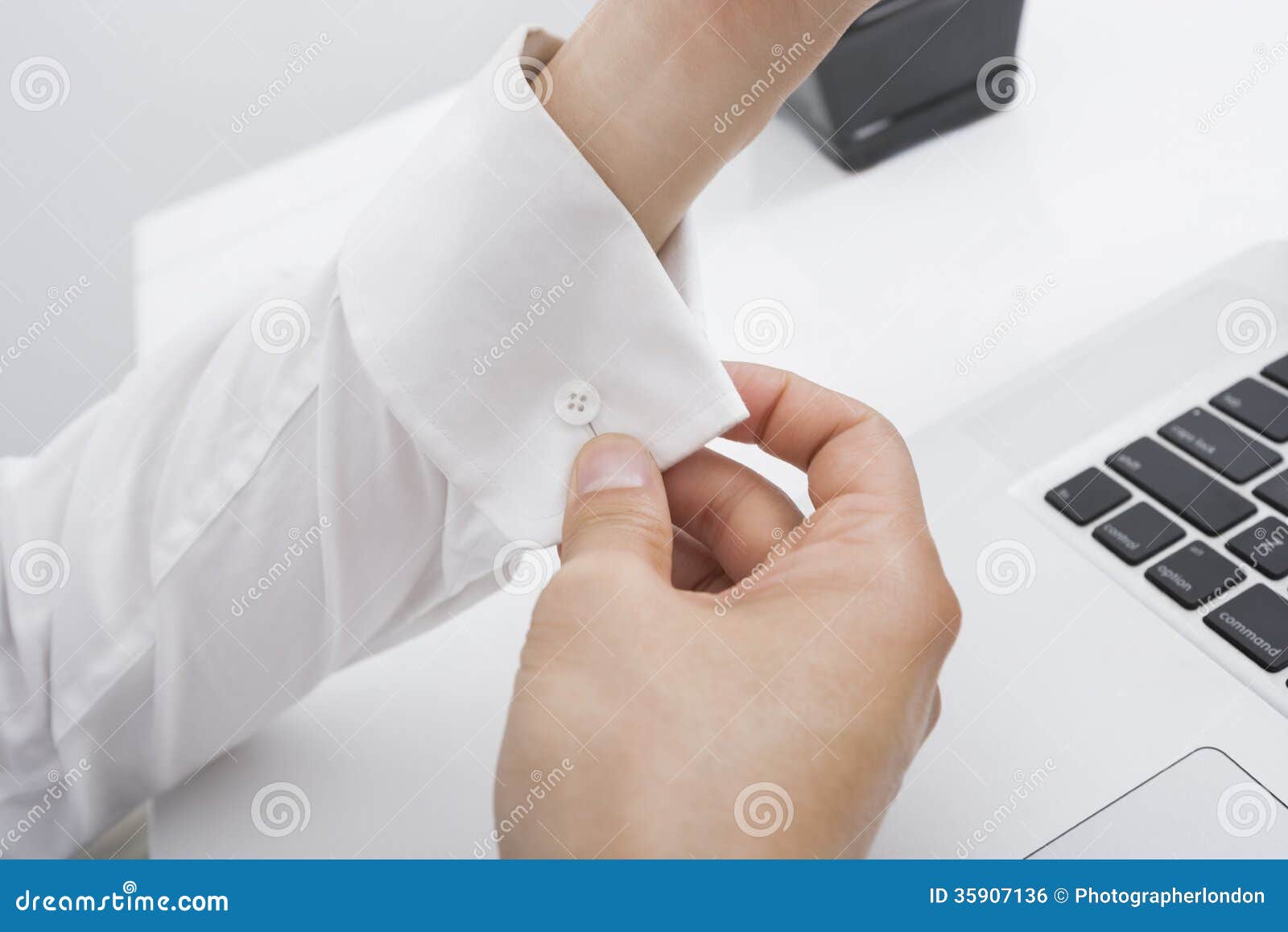 Cropped Image of Businessman Buttoning His Cuff in Office Stock Photo ...