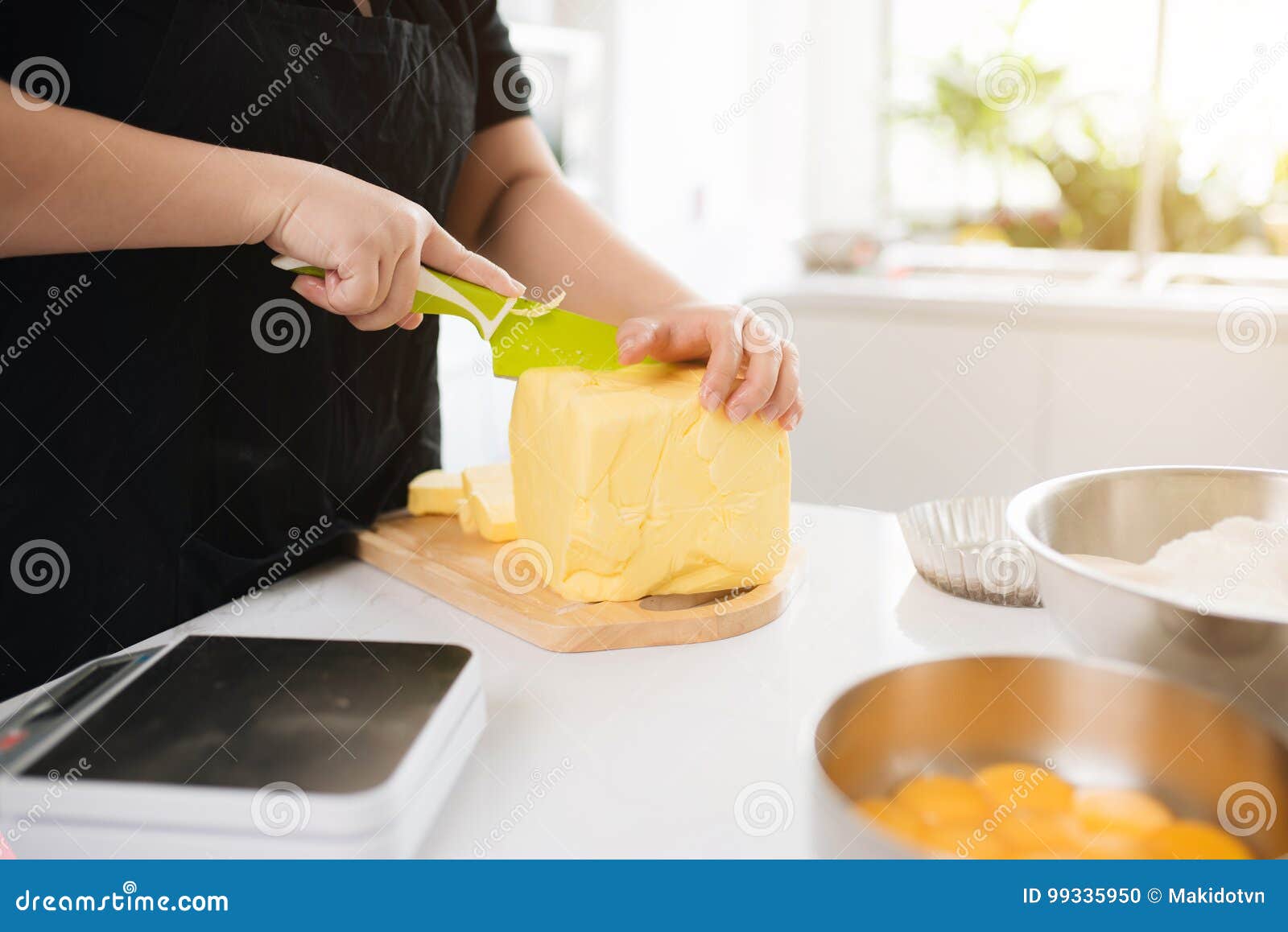 Cropped Image of Female Chef Cutting Butter in Kitchen Stock Photo ...