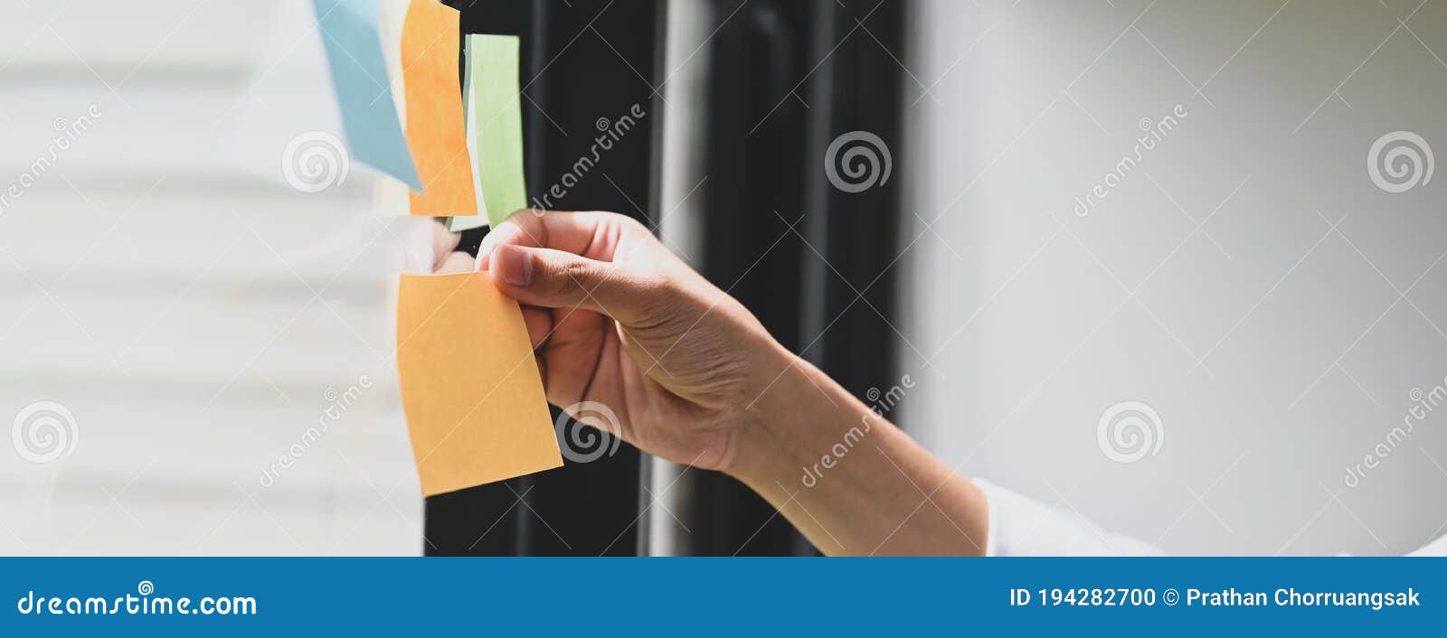 Cropped Image a Hand is Holding an Empty Sticky Note at the Glass Wall ...