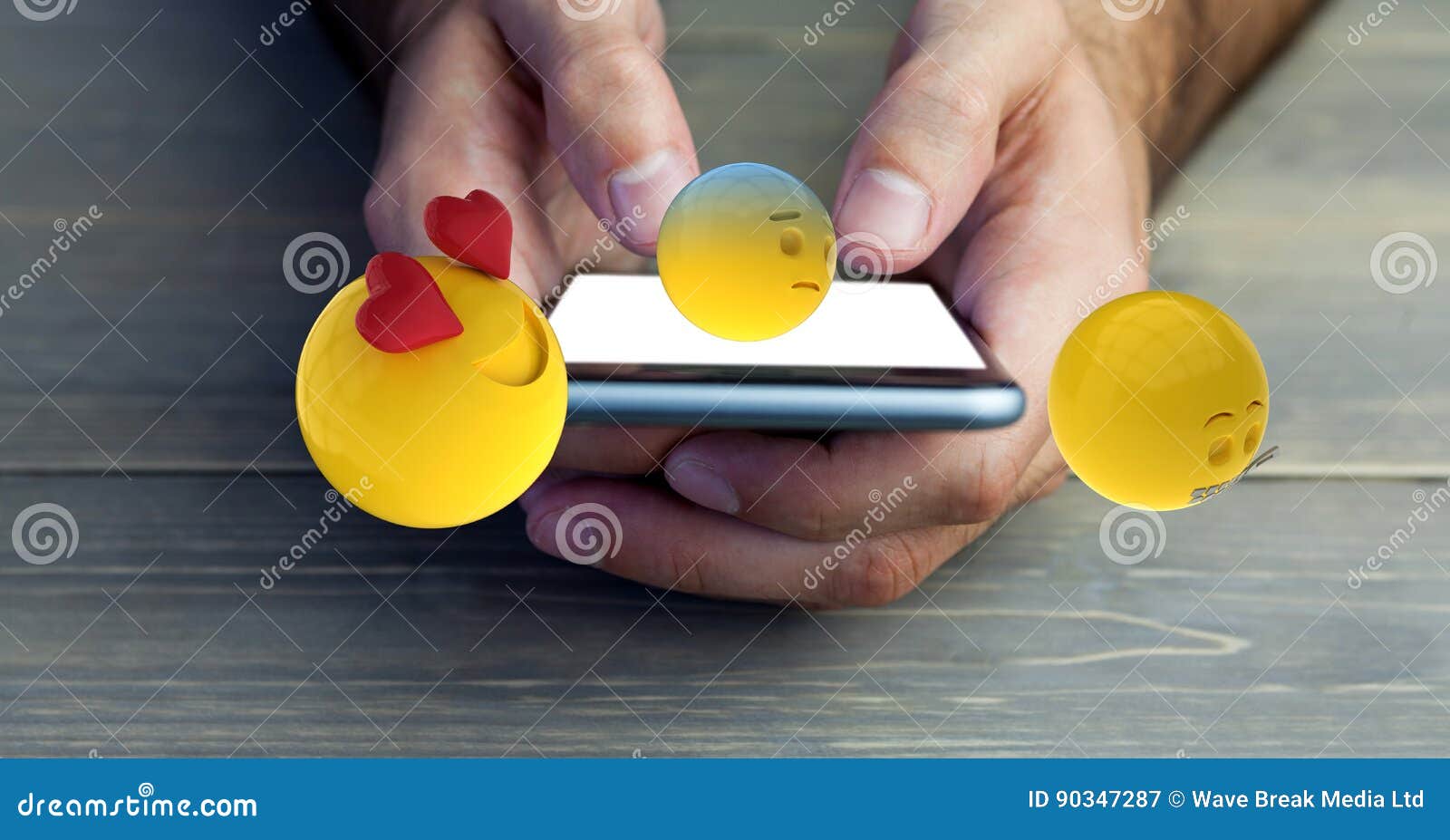 Cropped Image of Hands Holding Mobile Phone with Various Emojis at ...