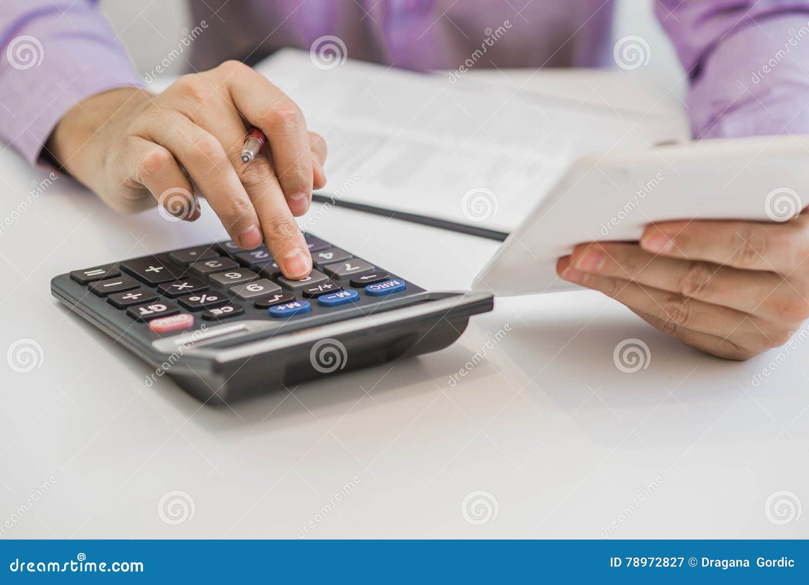Cropped Image of Handsome Old Man Using a Calculator and Writing in His ...