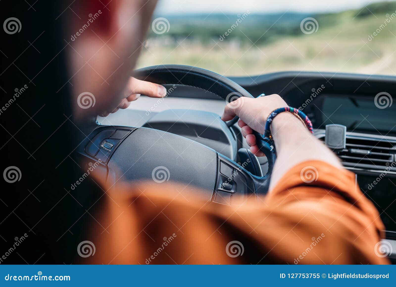 Cropped Image of Man Sitting Behind His Car Wheel Stock Image - Image ...