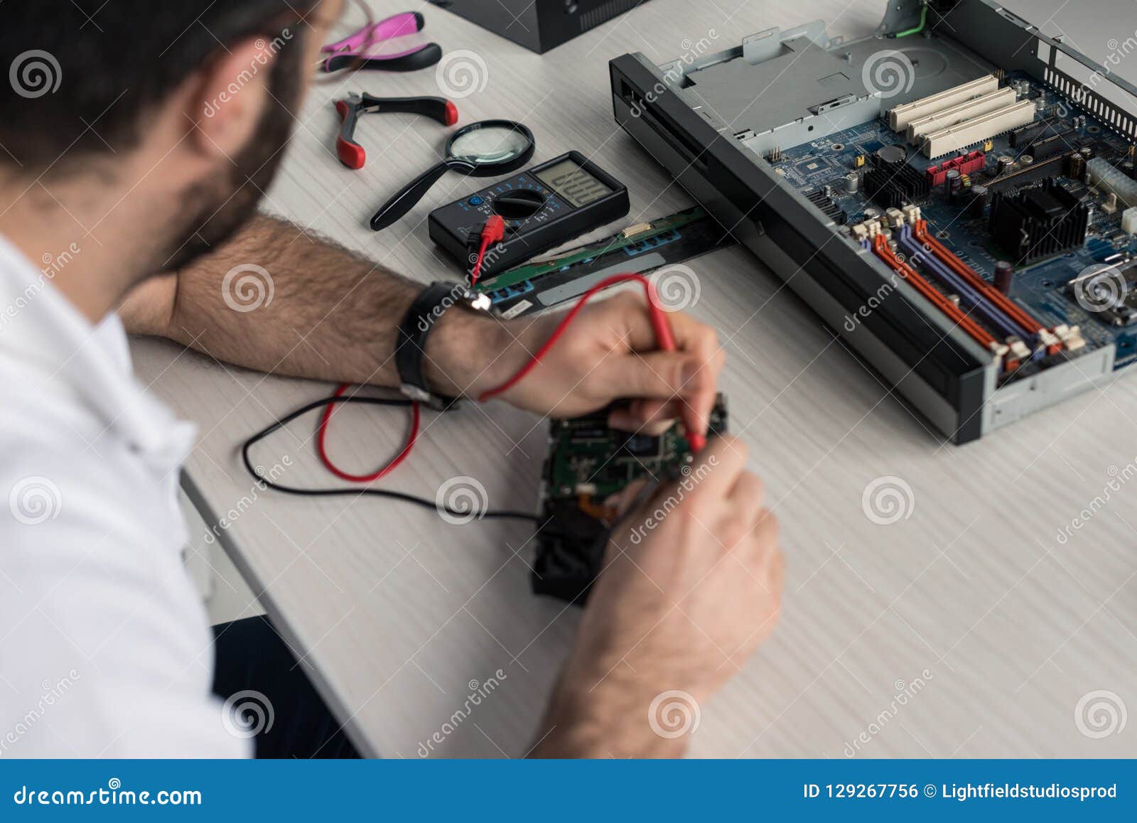 Cropped Image of Man Using Multimeter while Testing Hard Disk Drive ...