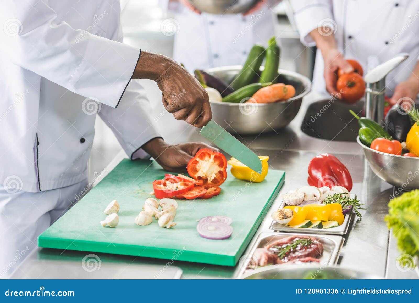 Cropped Image of Multicultural Chefs Cutting and Washing Vegetables ...