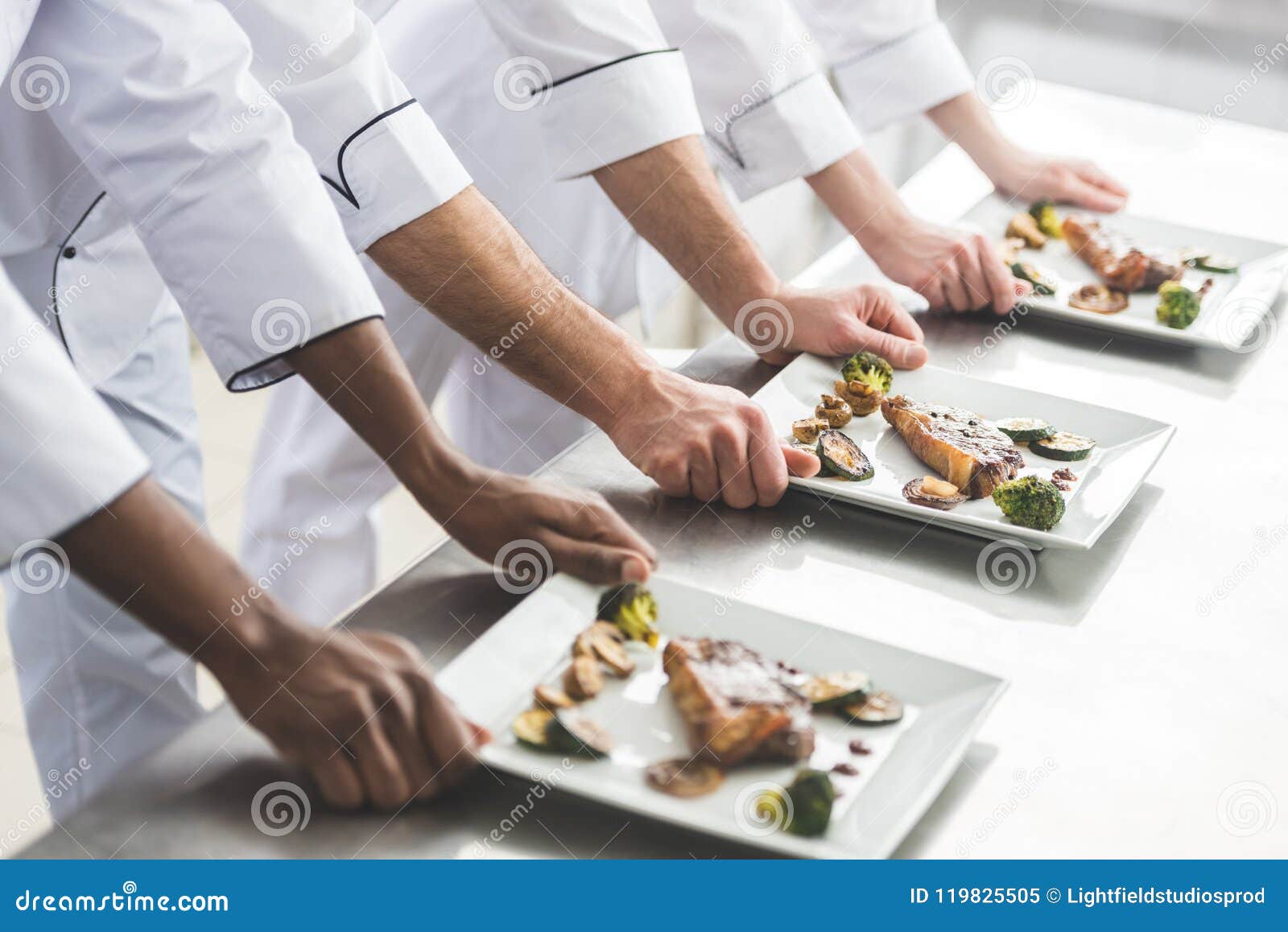 Cropped Image of Multicultural Chefs with Plates with Steaks at ...