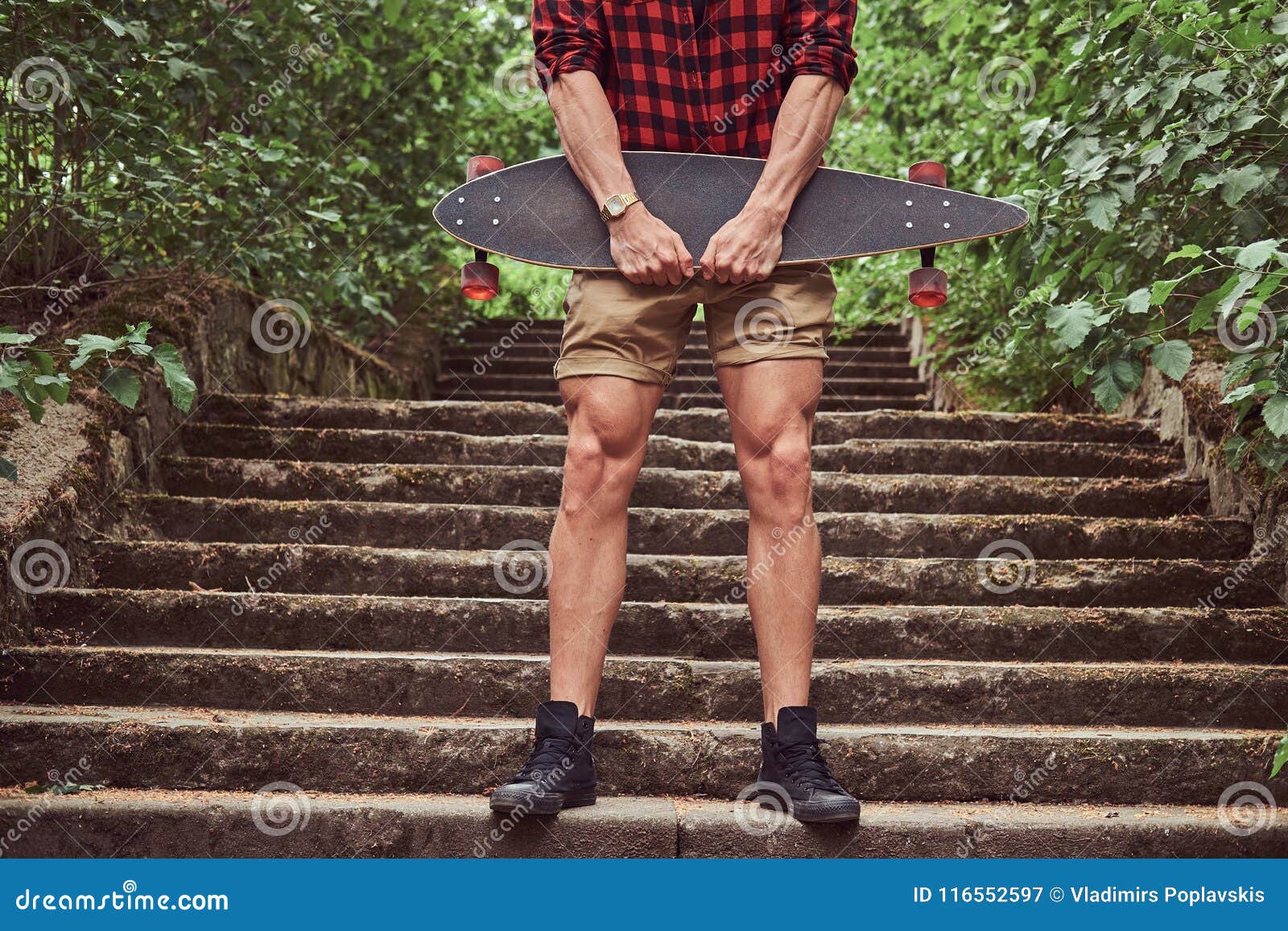 Cropped Image of a Muscular Skater, Standing on Steps, Holds the ...