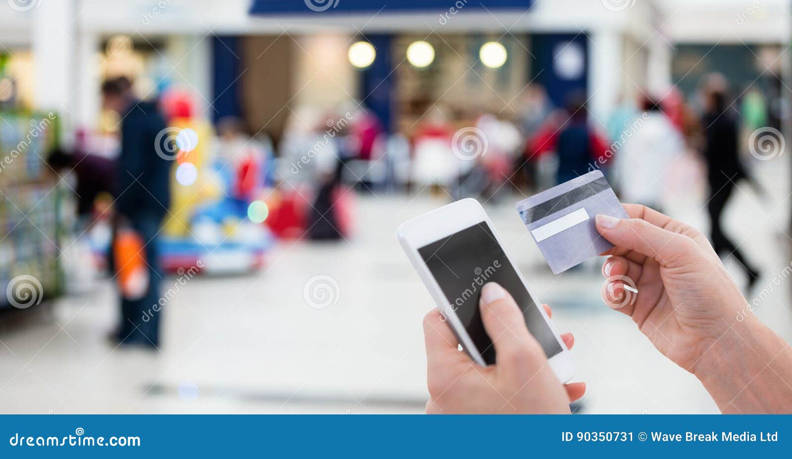 Cropped Image of Person Using Smart Phone for Paying Bill through Debit ...
