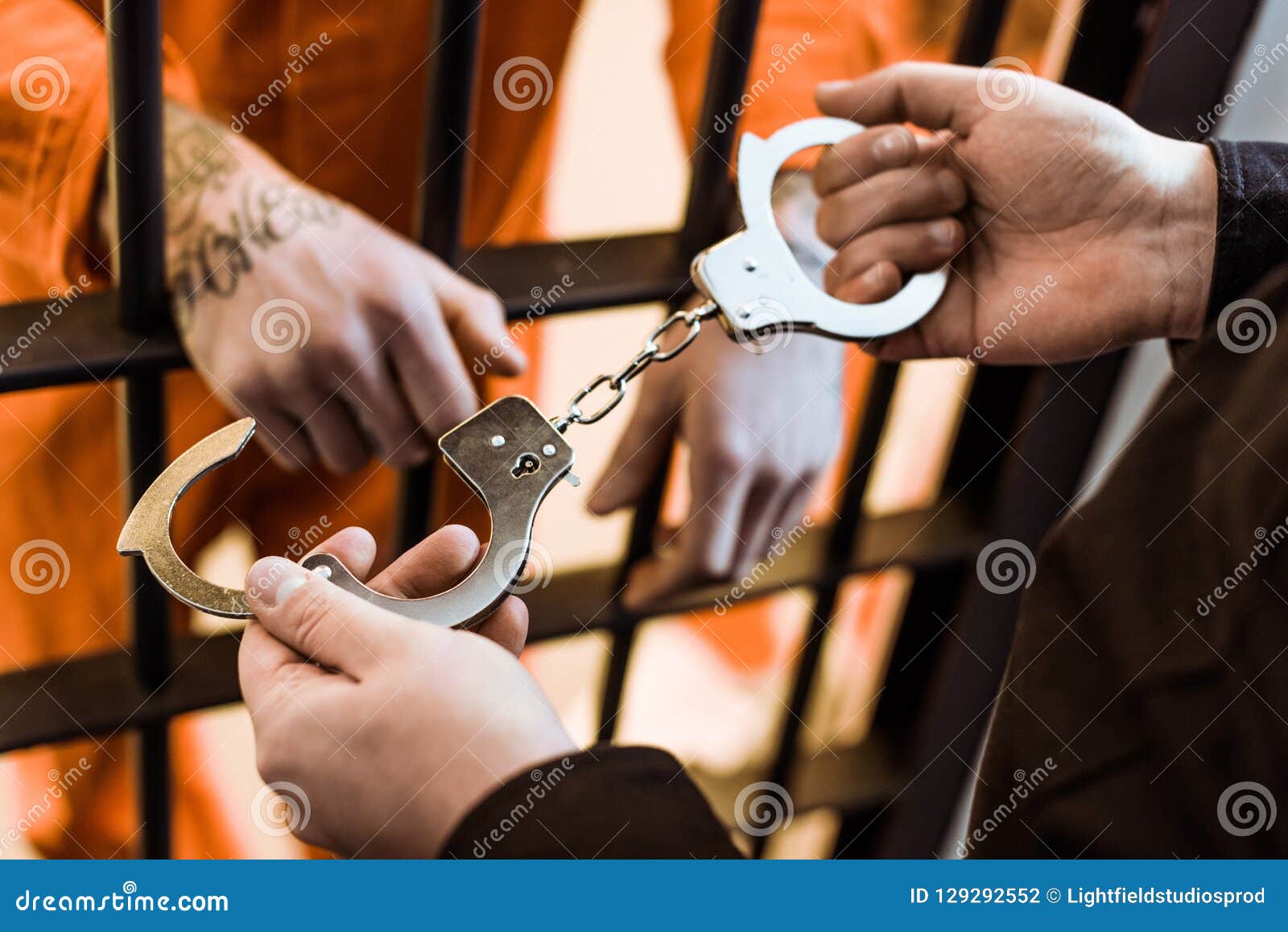 Cropped Image of Prison Officer Wearing Handcuffs Stock Photo - Image ...