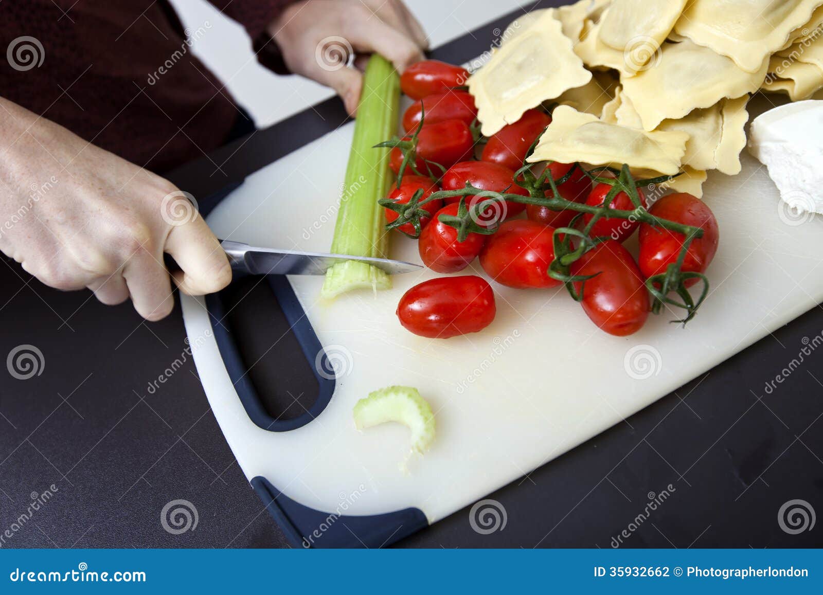 Cropped Image of Woman Chopping Cucumber at Kitchen Counter Stock Photo ...