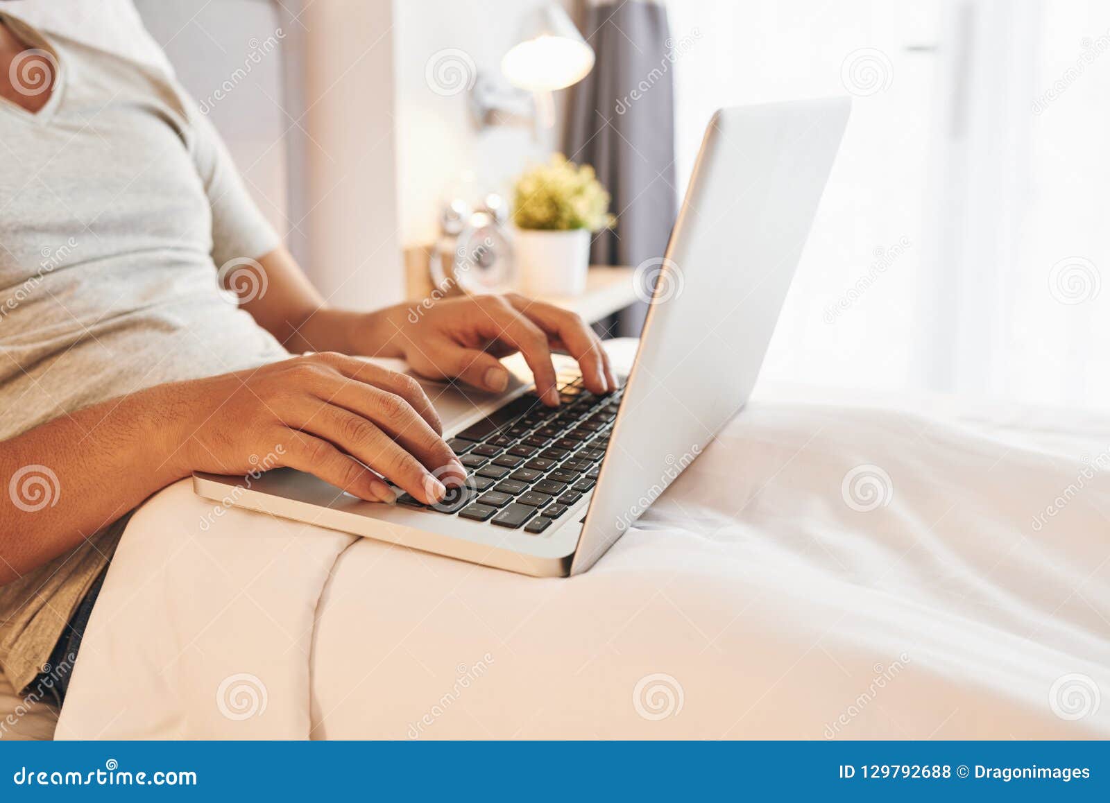 Working in bed stock photo. Image of portable, hands - 129792688
