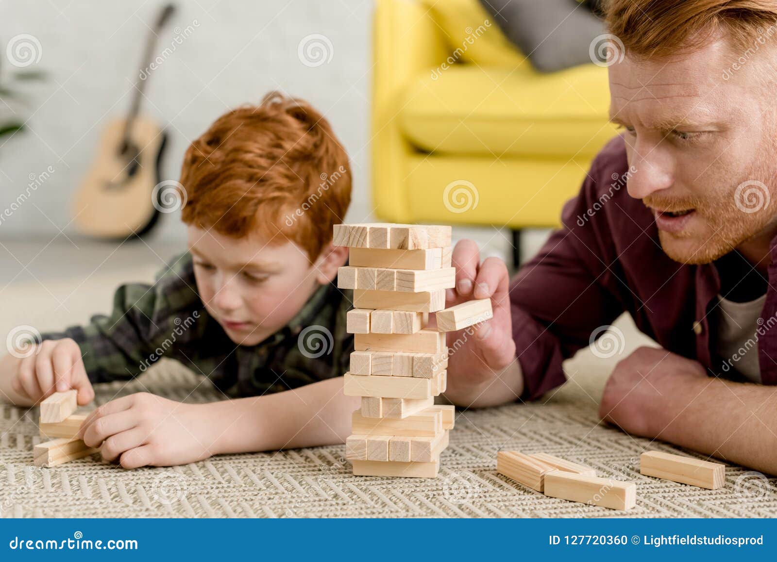 Cropped Shot of Concentrated Father and Son Building Towers from Wooden ... Cropped Shot of Concentrated Father and Son Building Towers from Wooden ...