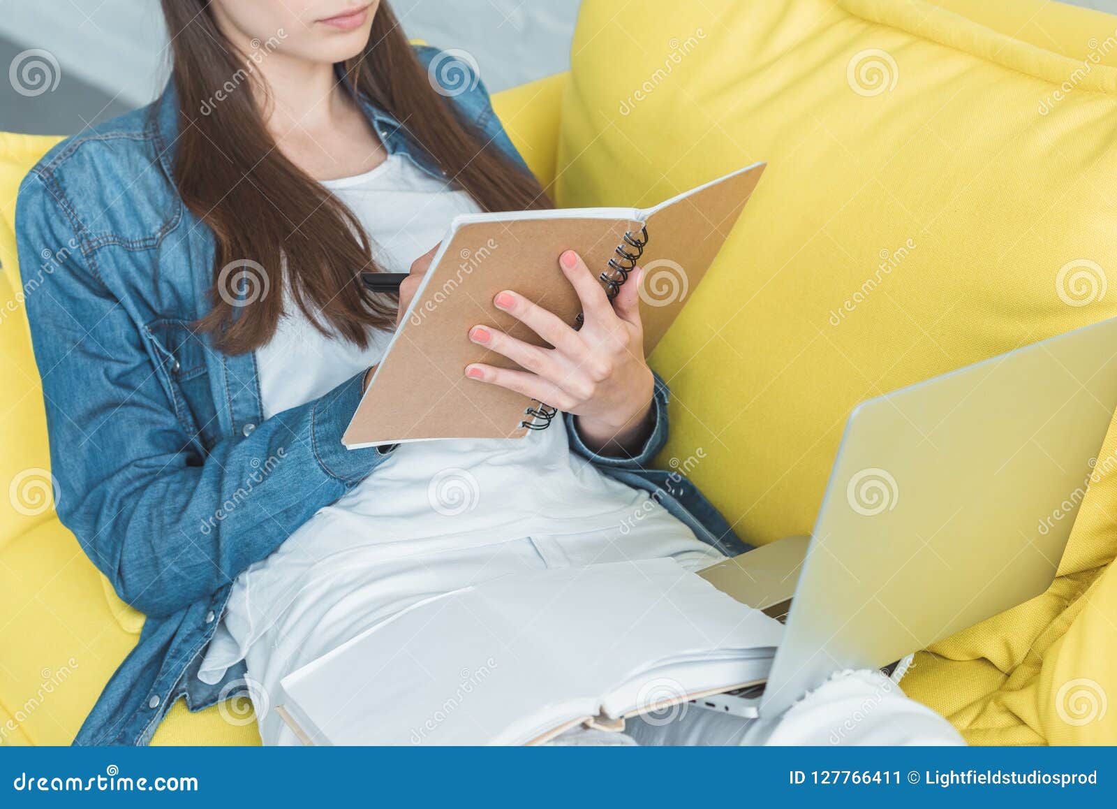 Cropped Shot of Girl Writing in Notebook and Using Laptop on Sofa Stock ...