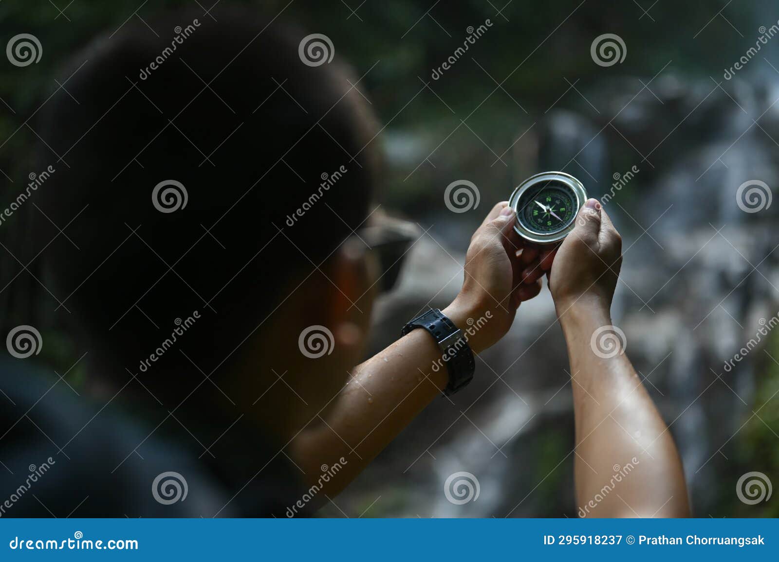 Cropped Shot of Male Traveller Using Compass To Navigate during Hiking ...