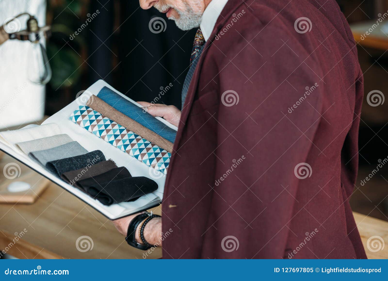 Cropped Shot of Mature Tailor with Catalogue of Cloth Types Stock Image ...