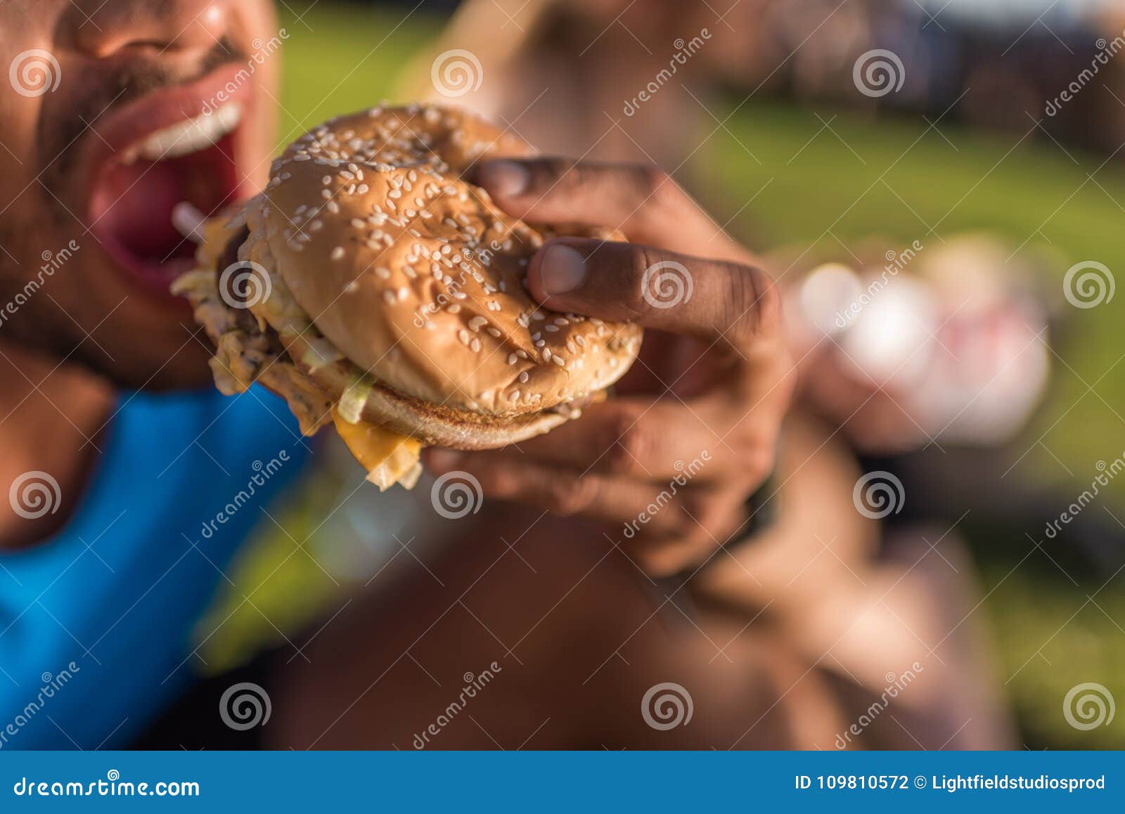 Man biting hamburger stock photo. Image of partial, biting - 109810572