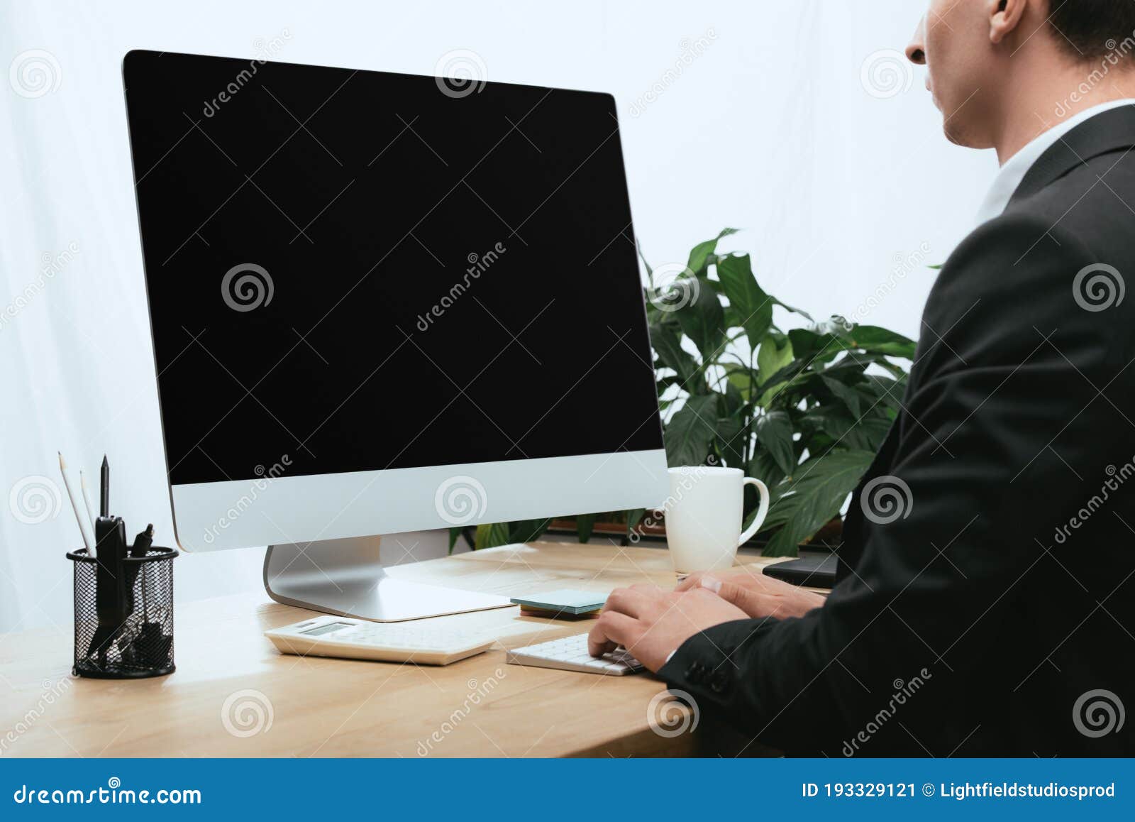 View of Man Using Computer with Blank Screen in Office Stock Image ...