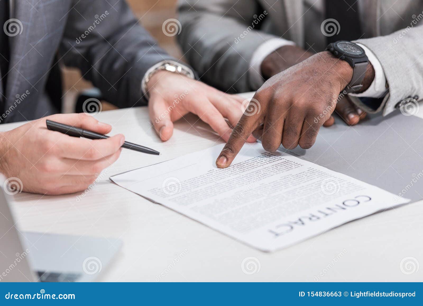 Cropped View of Multiethnic Business Partners Signing Contract Stock ...