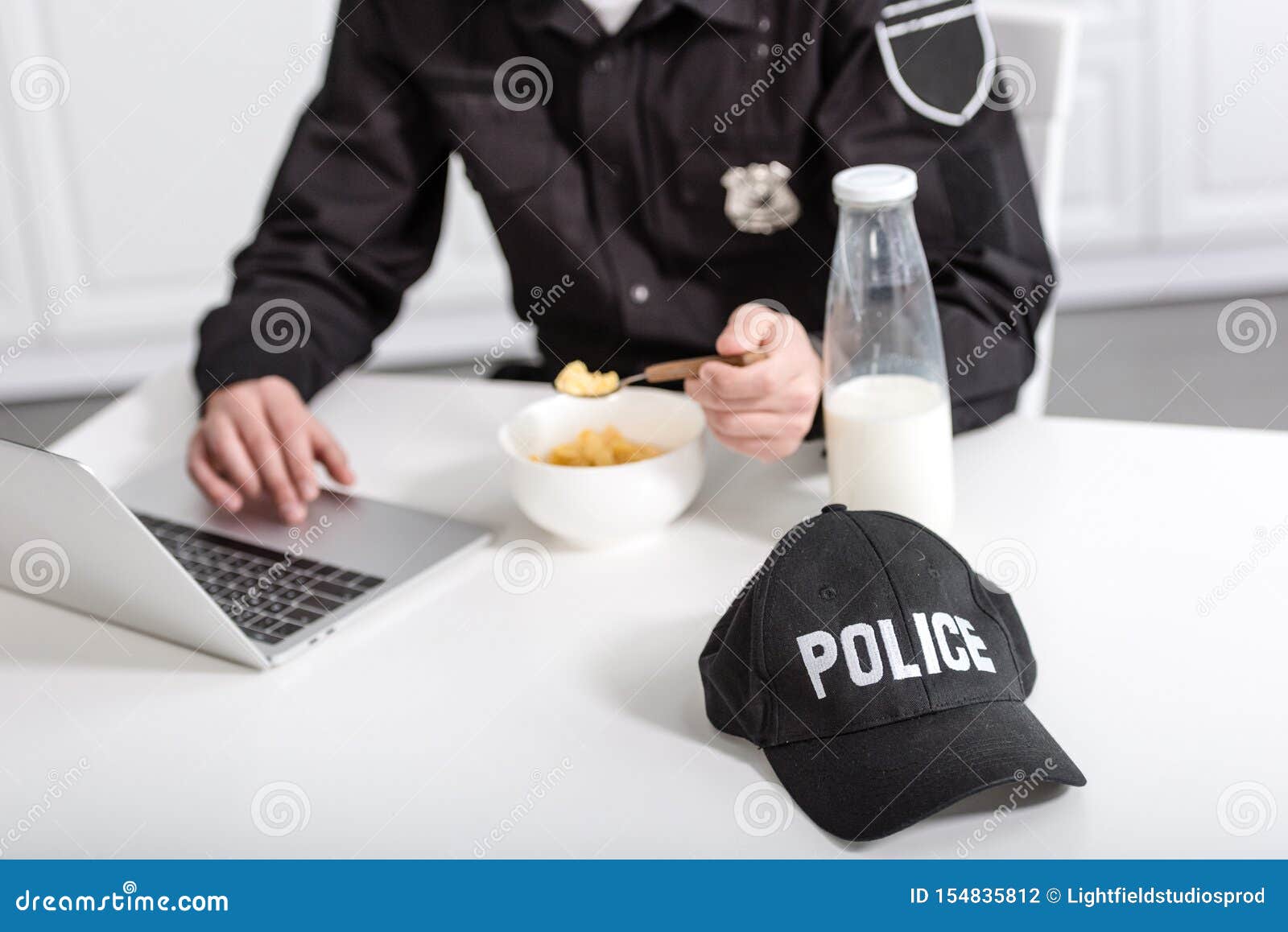 Cropped View of Police Officer Using Laptop and Eating Cornflakes Stock ...
