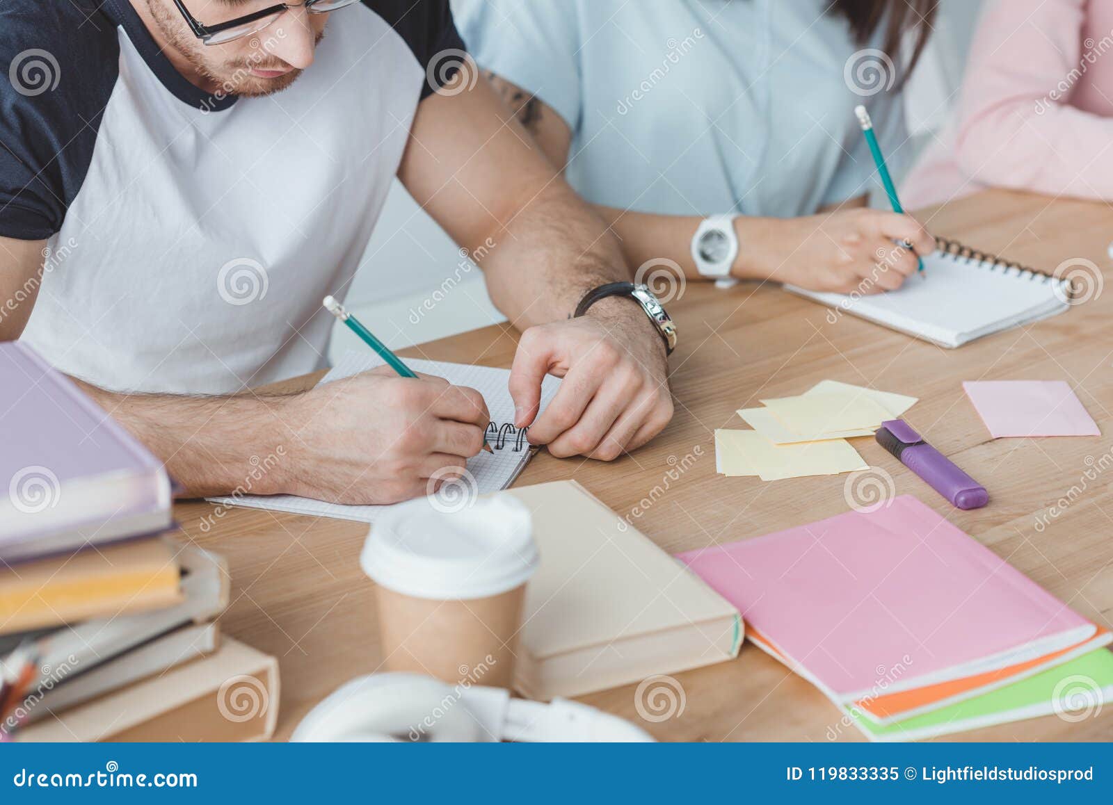 Cropped View of Young Students Writing in Copybooks Stock Image - Image ...