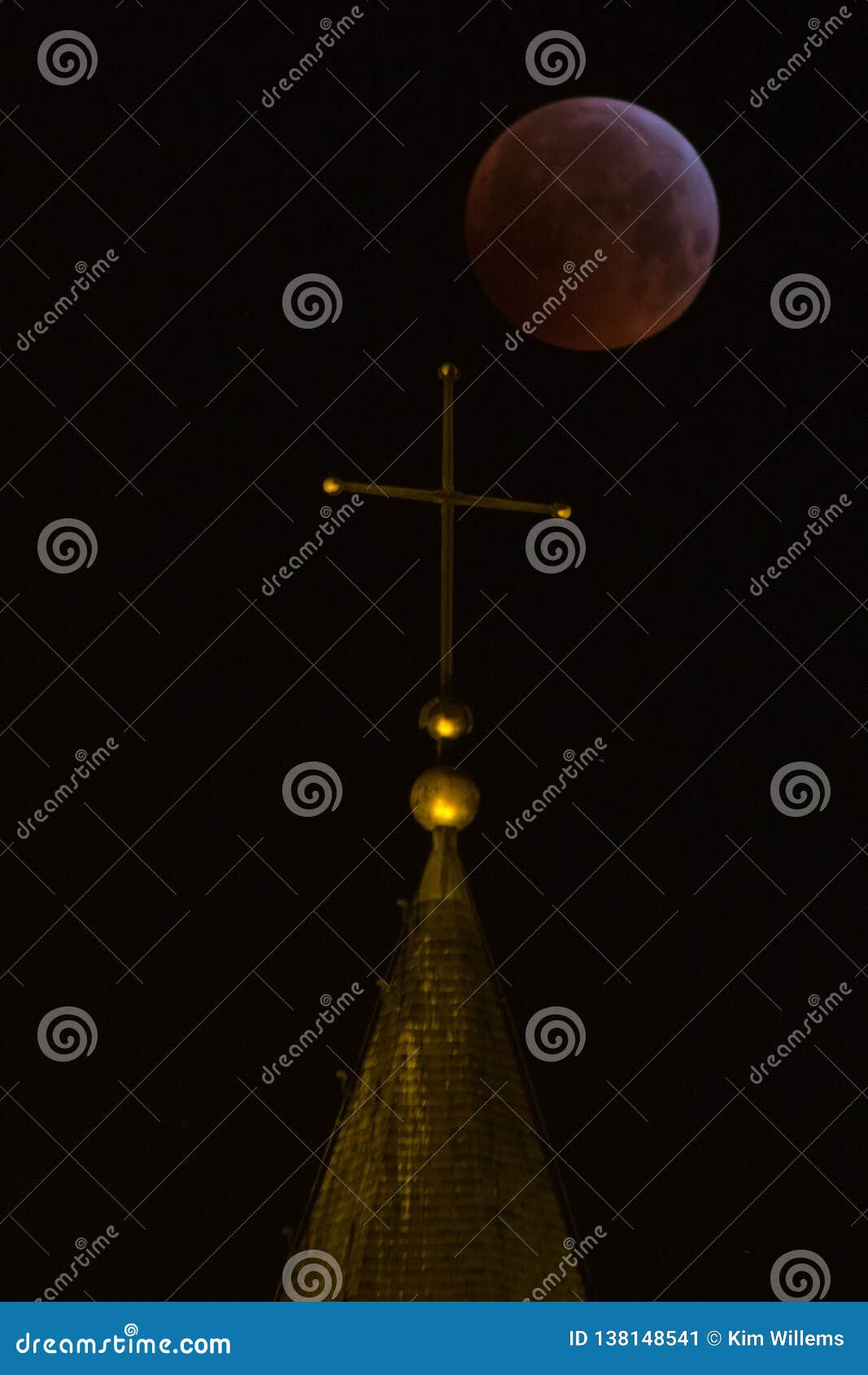 Cross below a moon eclipse stock image. Image of january - 138148541