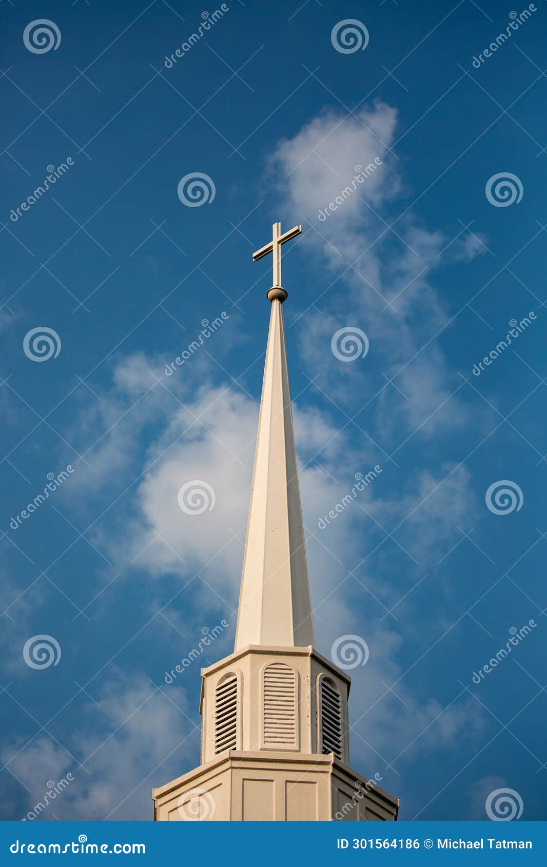 Cross and Church Steeple with Sun Lighting it and Blue Sky in the ...