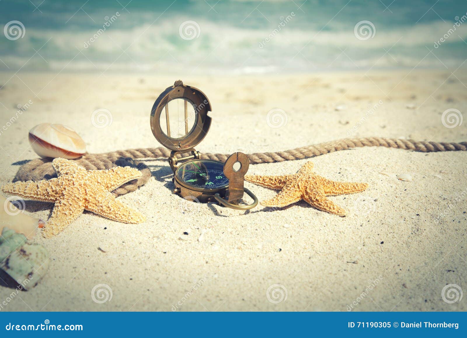Cross-processed Compass with Shells and Rope on Ocean Beach Stock Image ...