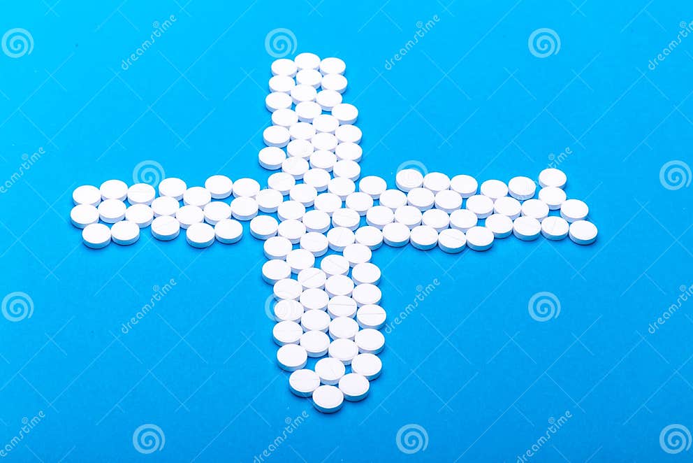 Cross of Tablets on a Blue Background Stock Image - Image of pharmacy ...